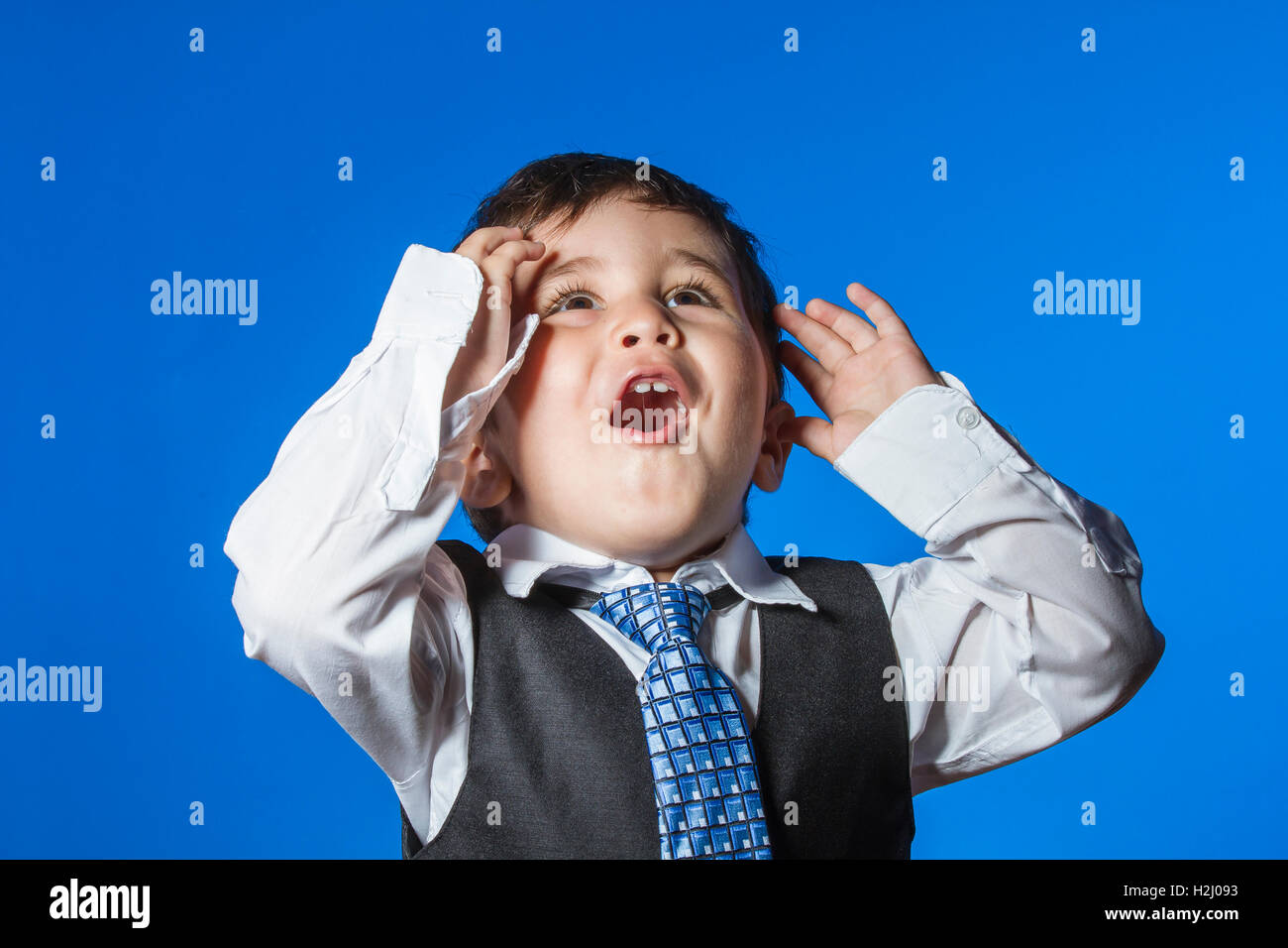 Leader, cute little boy portrait over blue chroma background Stock ...