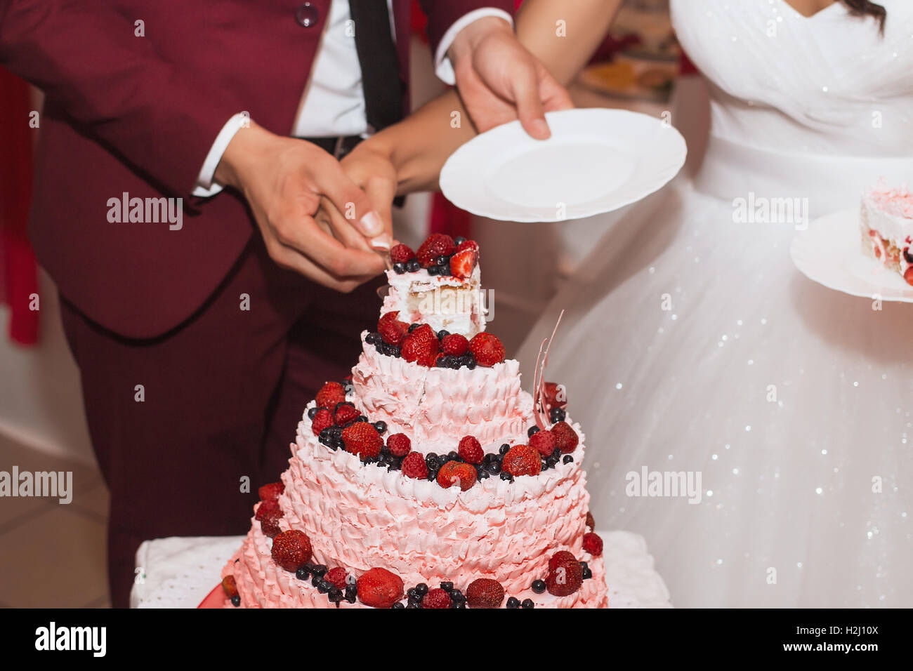 elegant pretty young bride and groom cut the wedding cake Stock Photo ...