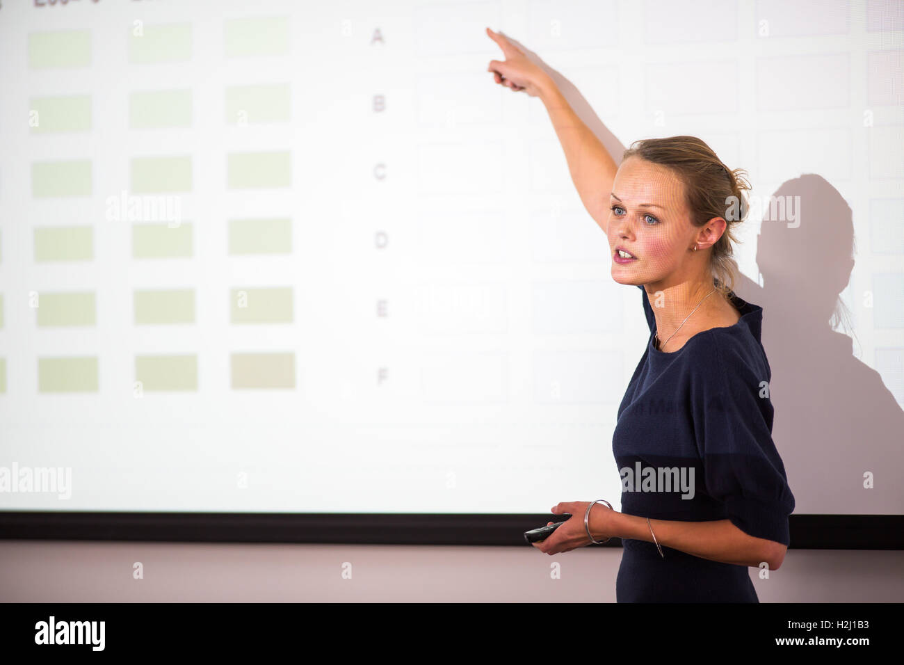 Pretty, young business woman giving a presentation Stock Photo - Alamy