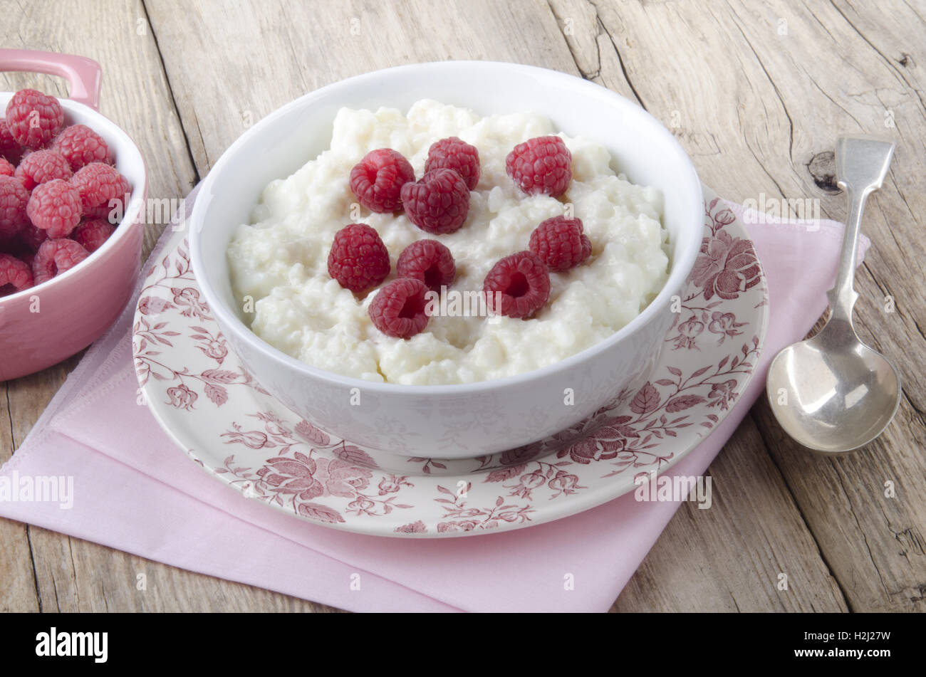 warm rice pudding with raspberry Stock Photo - Alamy