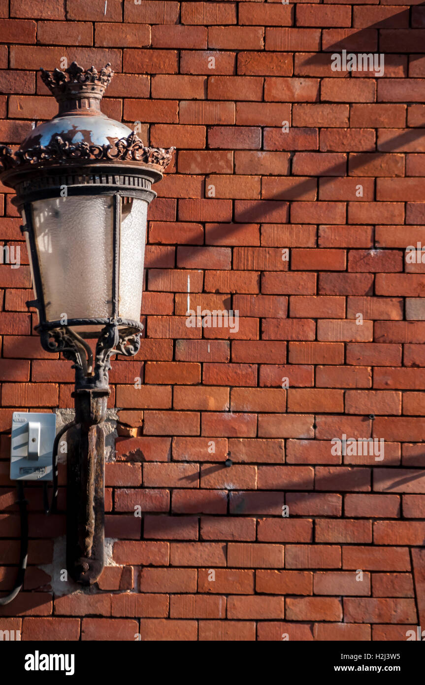Street light on stone wall, spain Stock Photo - Alamy