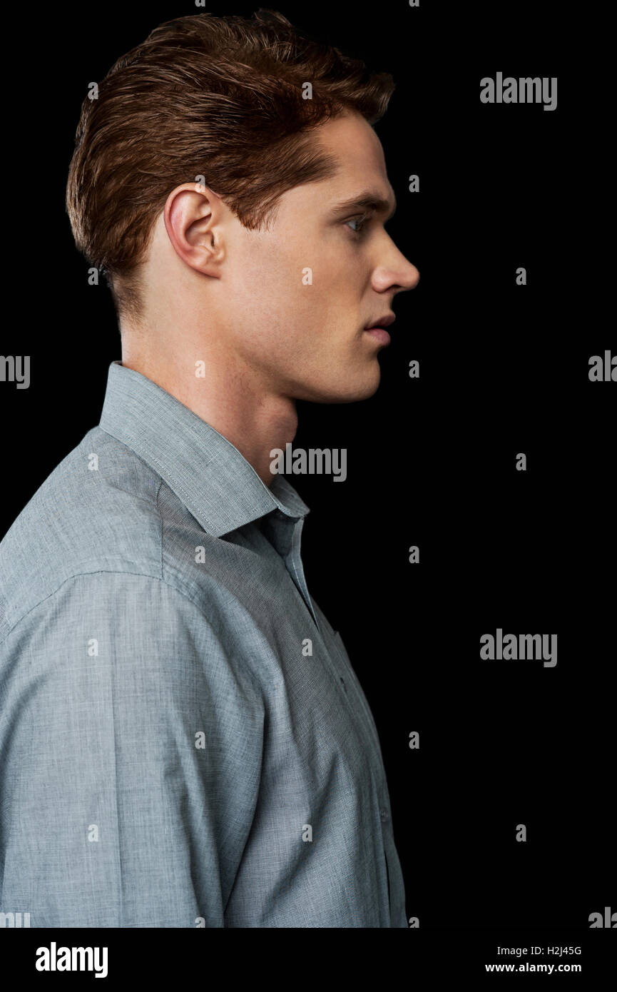 Side pose of stylish young man Stock Photo - Alamy
