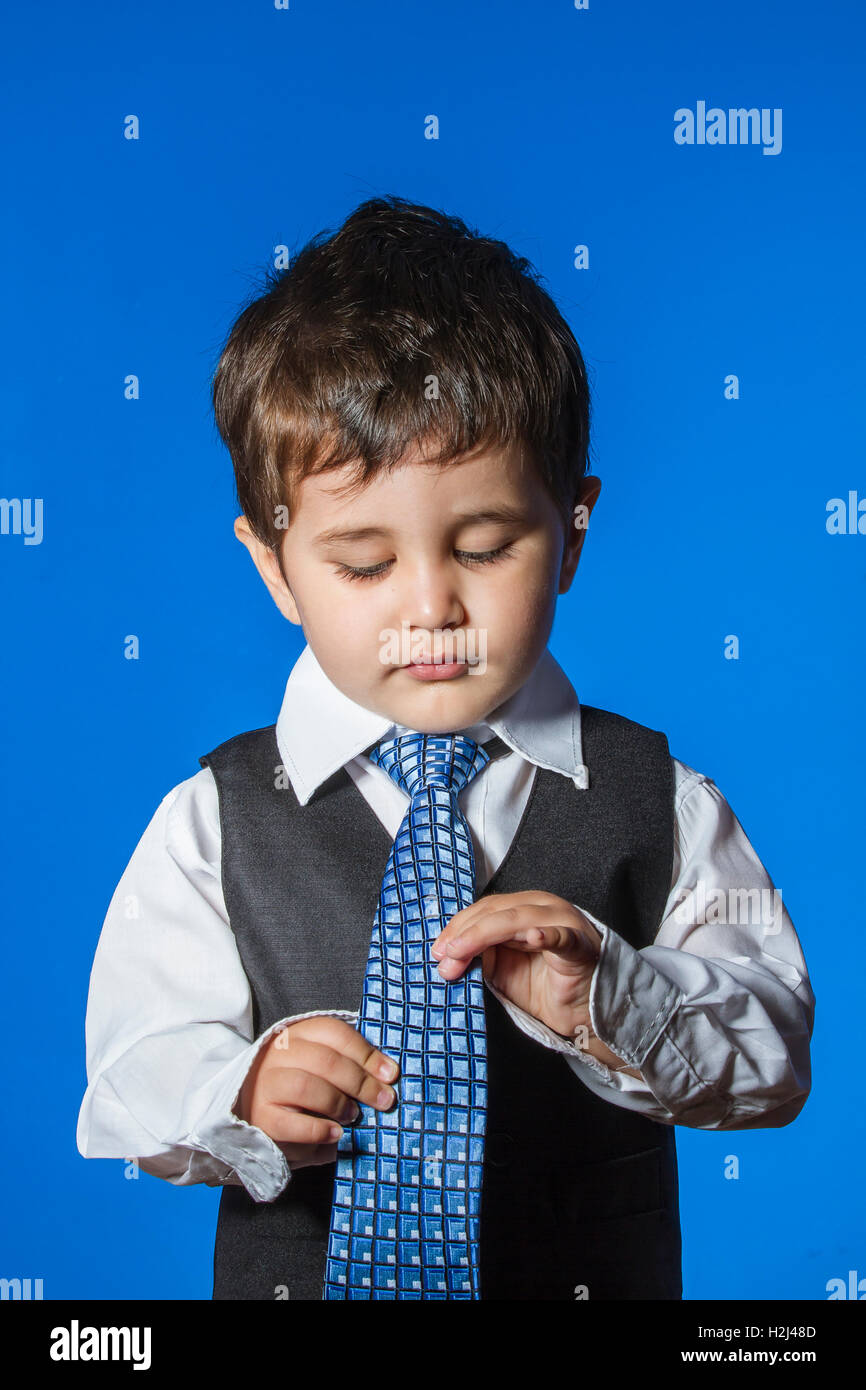 Leader, cute little boy portrait over blue chroma background Stock ...