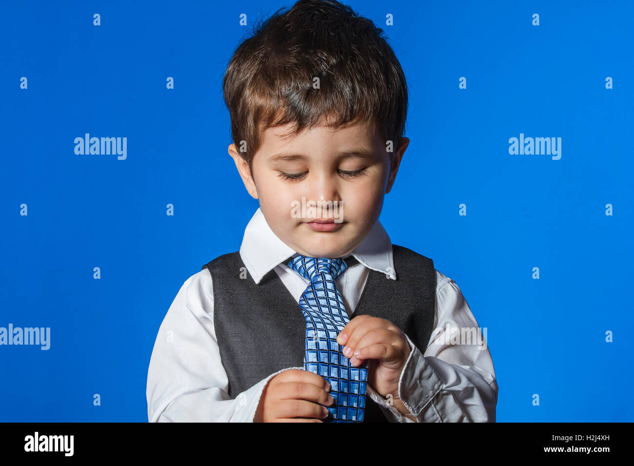Leader, cute little boy portrait over blue chroma background Stock ...
