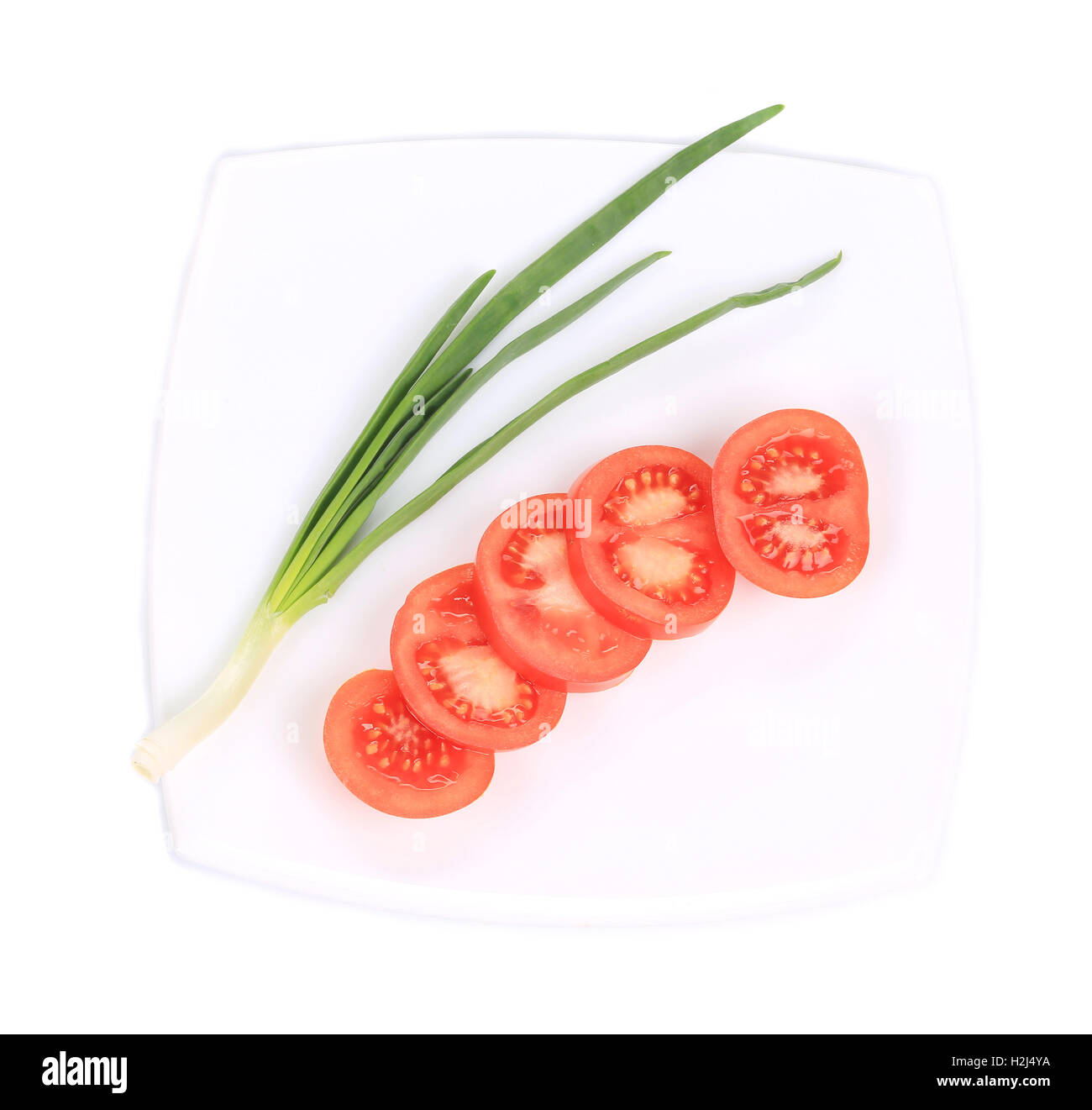 Spring onions and sliced tomatoes Stock Photo - Alamy