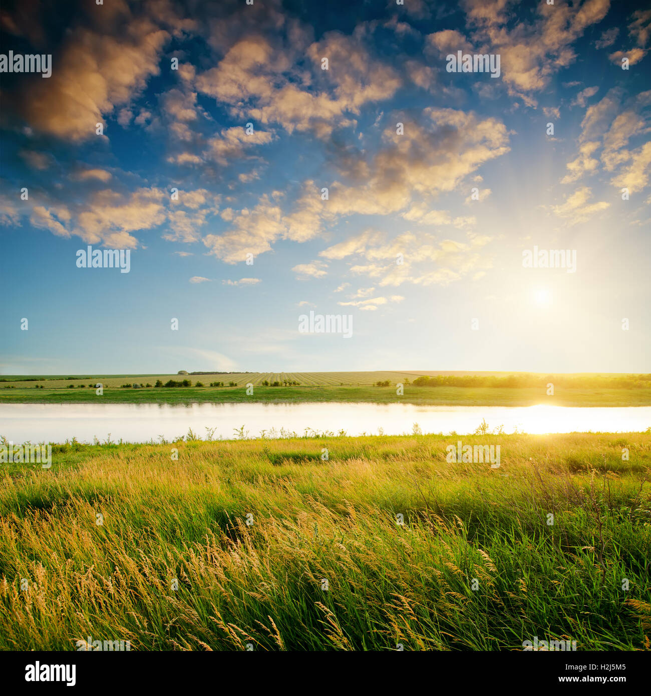 sunset over river Stock Photo - Alamy