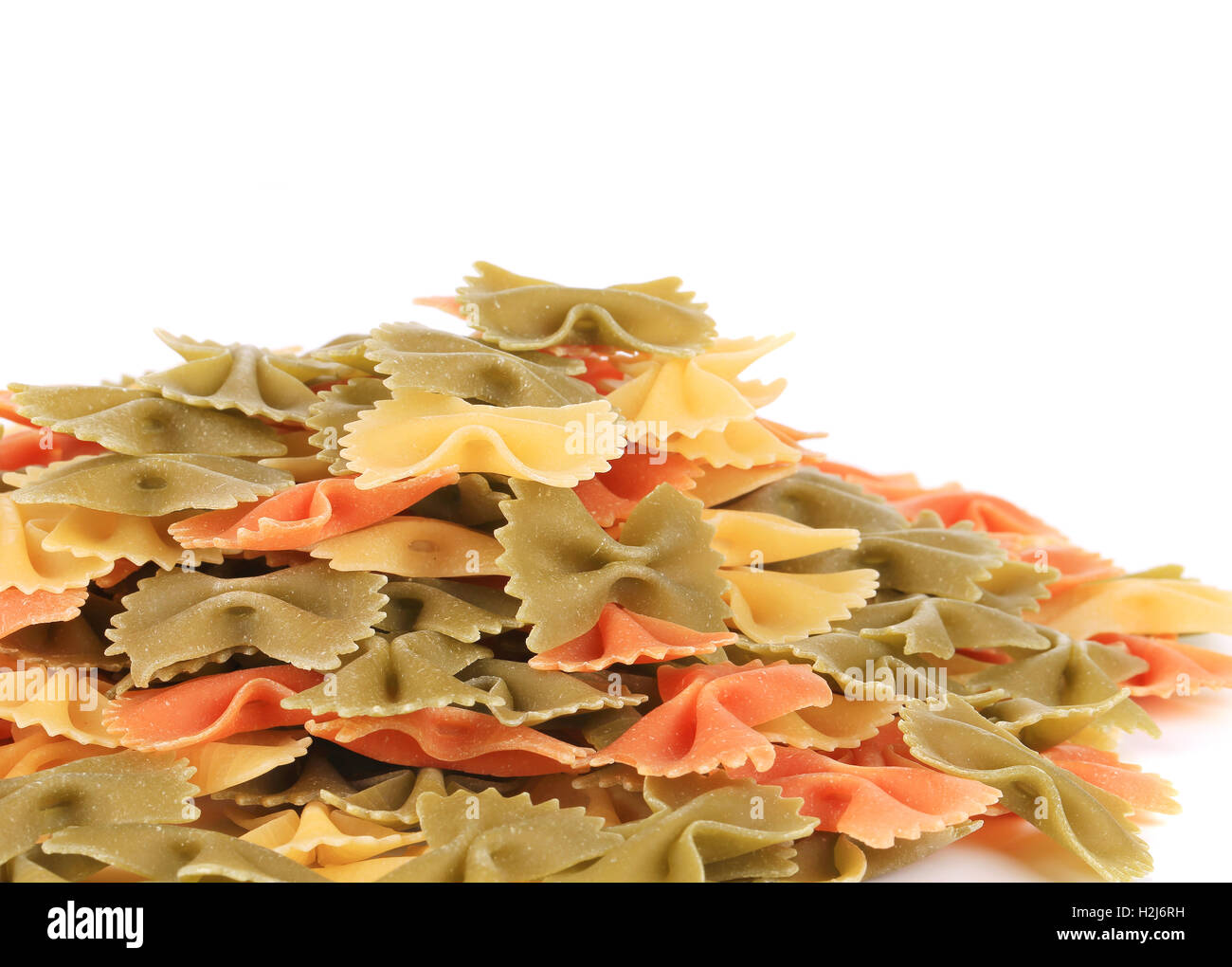 background of the farfalle pasta three colors Stock Photo - Alamy