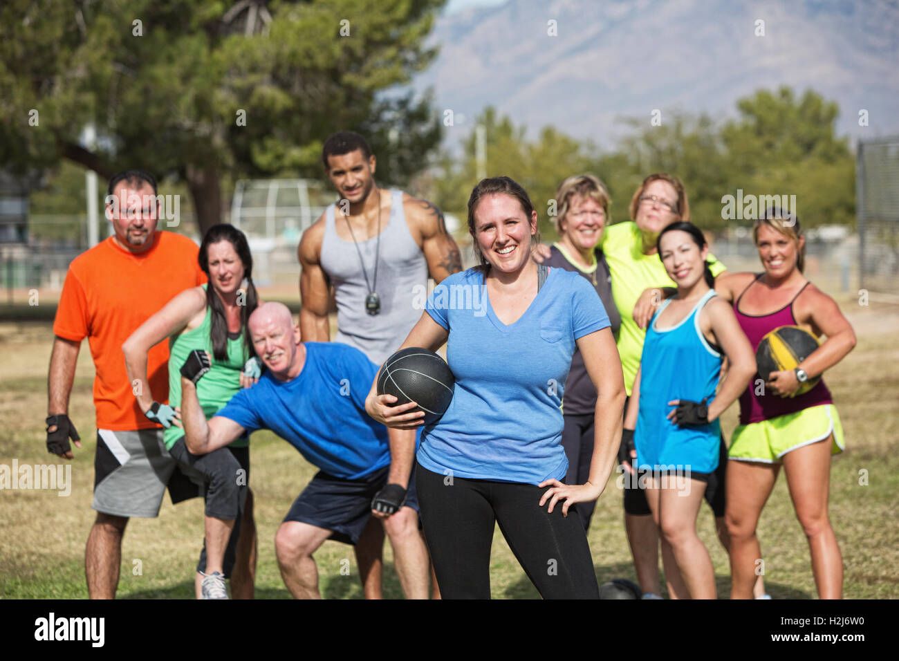 Confident Fit Woman with Group Stock Photo - Alamy