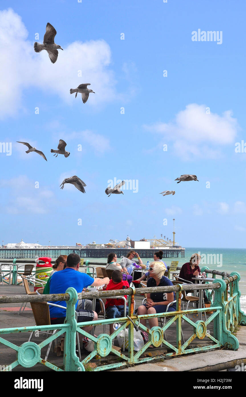Visitors enjoying view of Brighton seafront from seafront bar Stock ...
