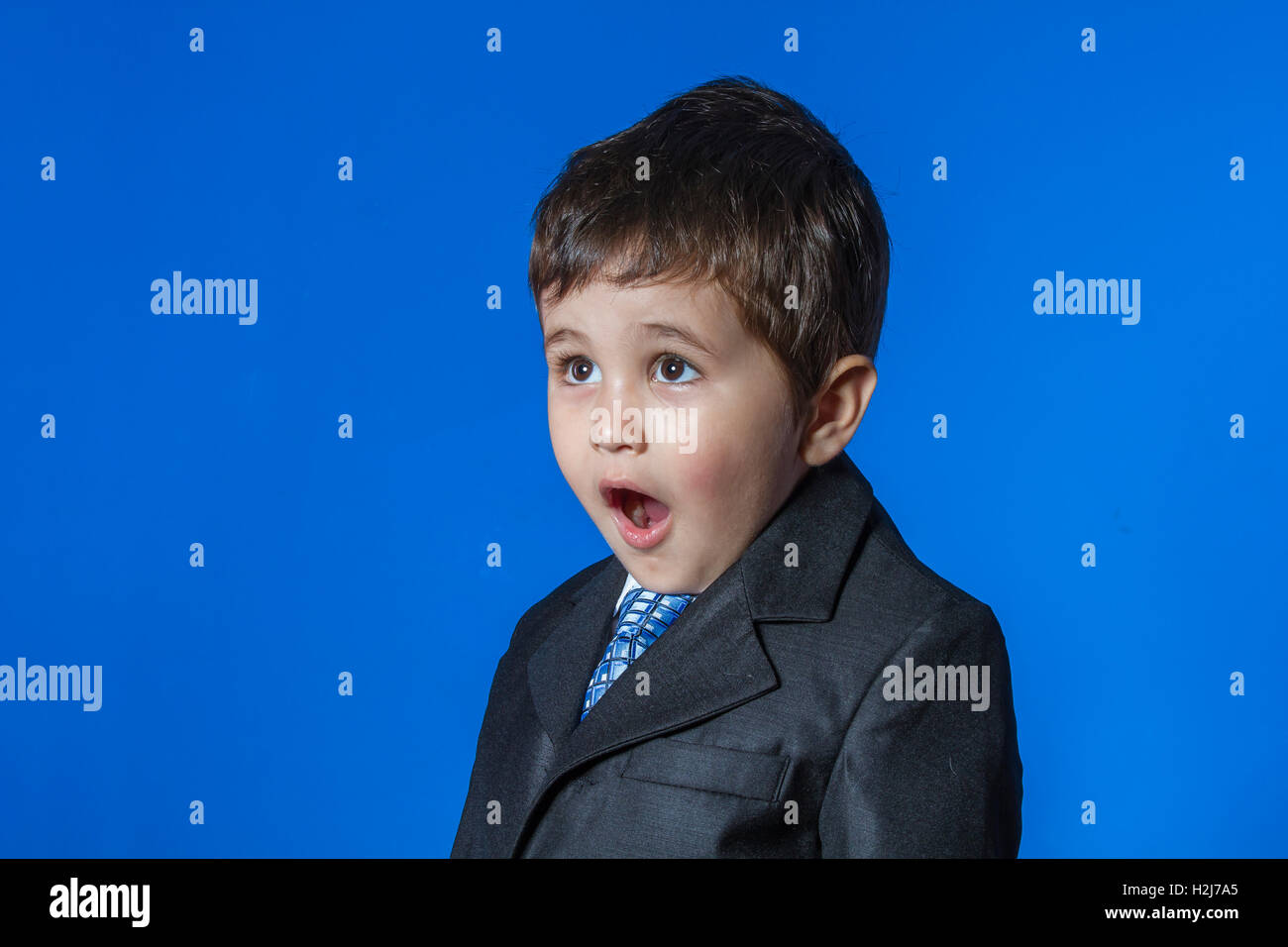 Leader, cute little boy portrait over blue chroma background Stock ...