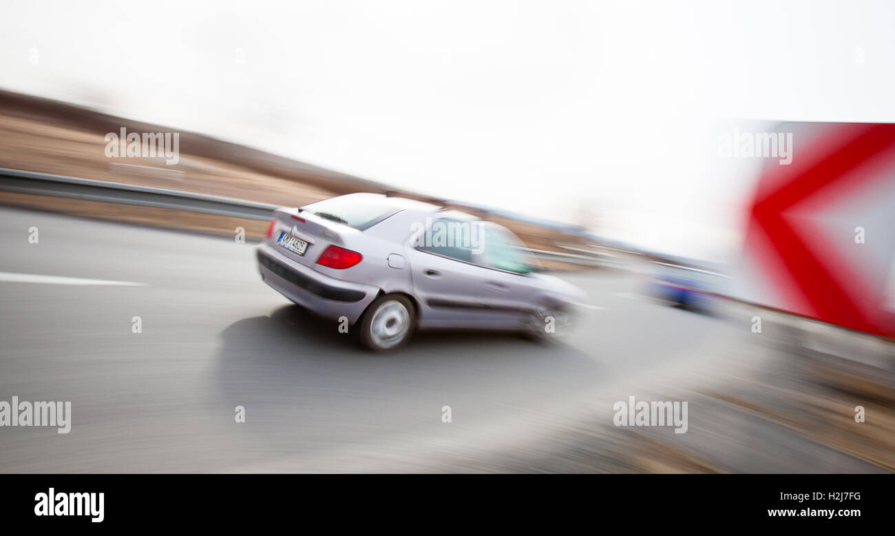 Traffic concept: car driving fast through a sharp turn Stock Photo - Alamy