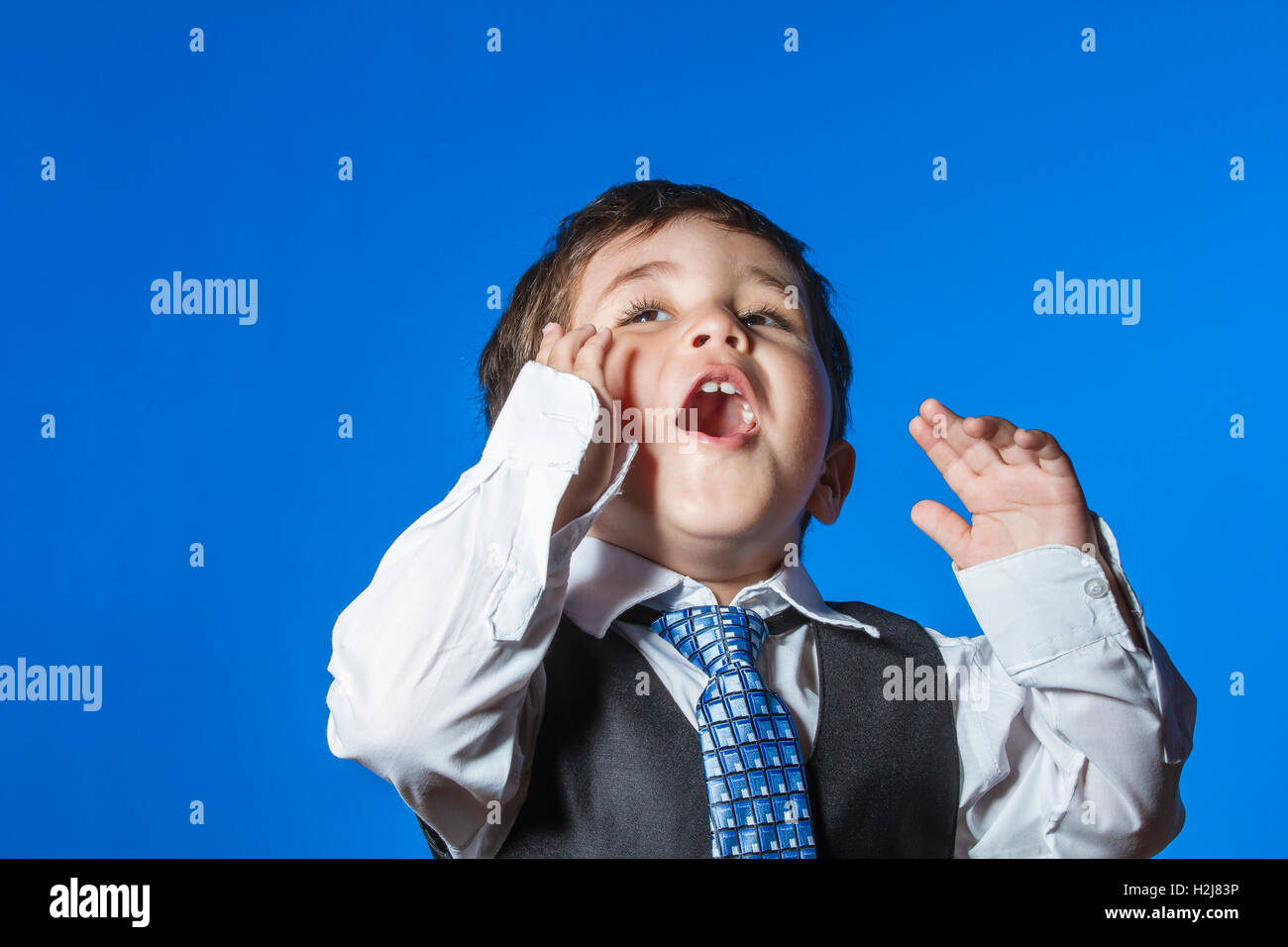 Leader, cute little boy portrait over blue chroma background Stock ...