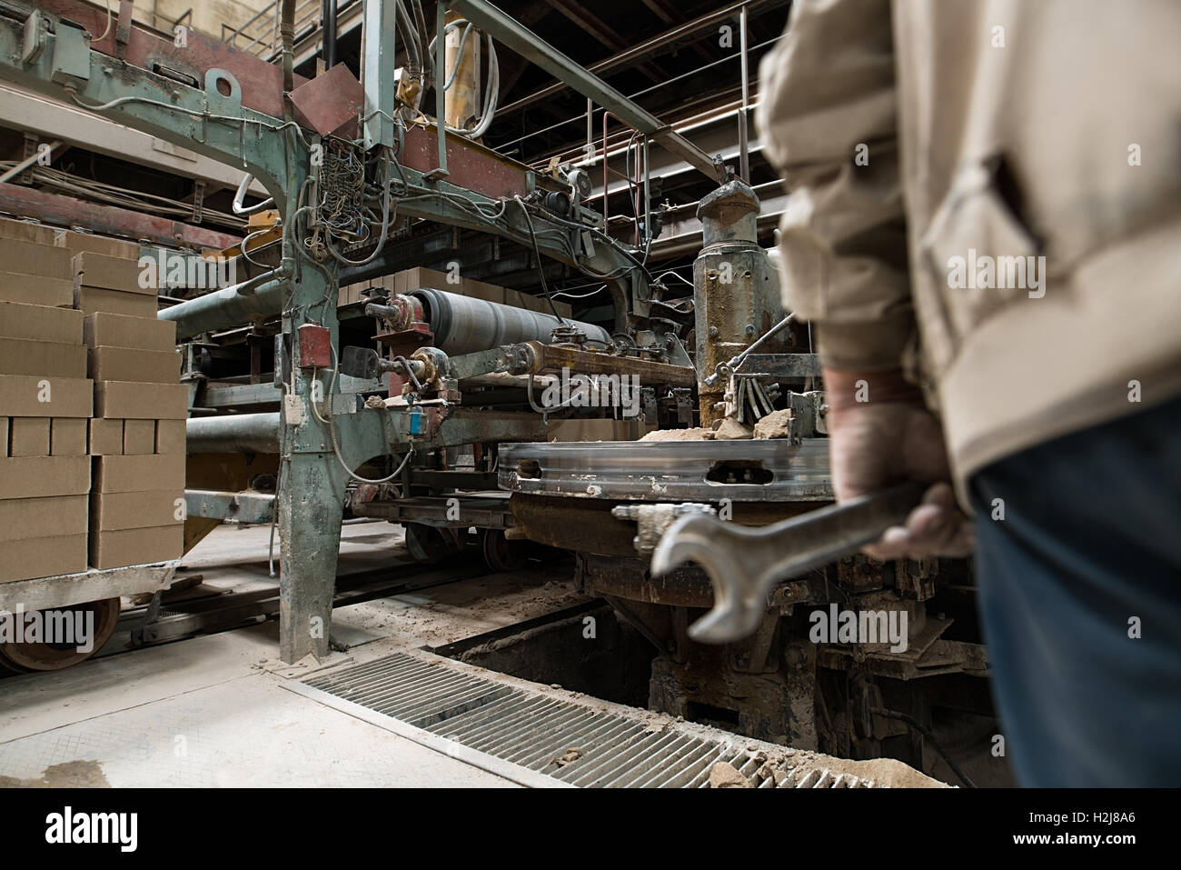 Image of worker in workshop for bricks production Stock Photo - Alamy