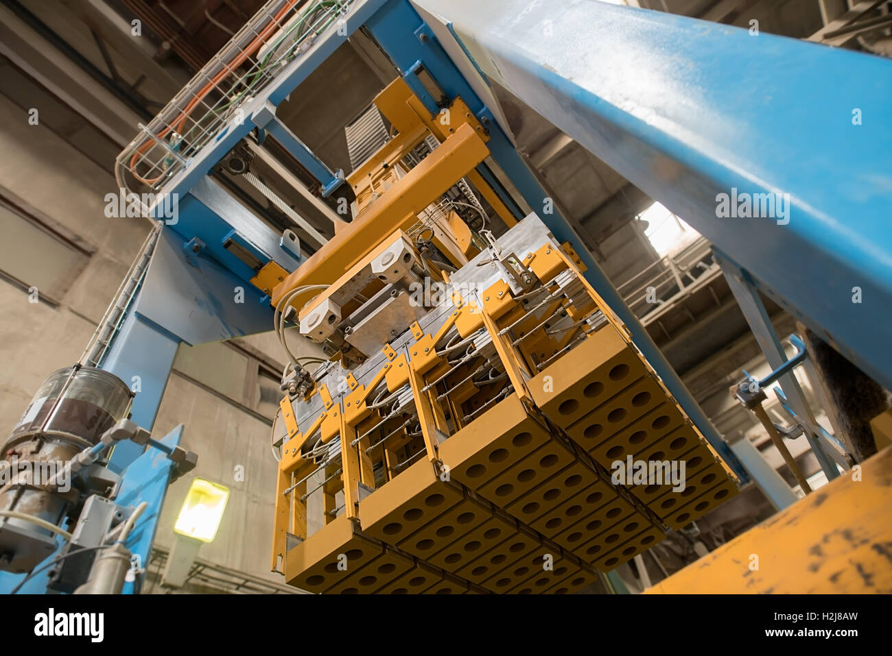 Bottom view of production machine with bricks Stock Photo - Alamy