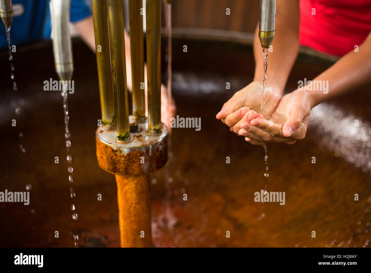 People filling up their hands with healthy mineral water Stock Photo ...