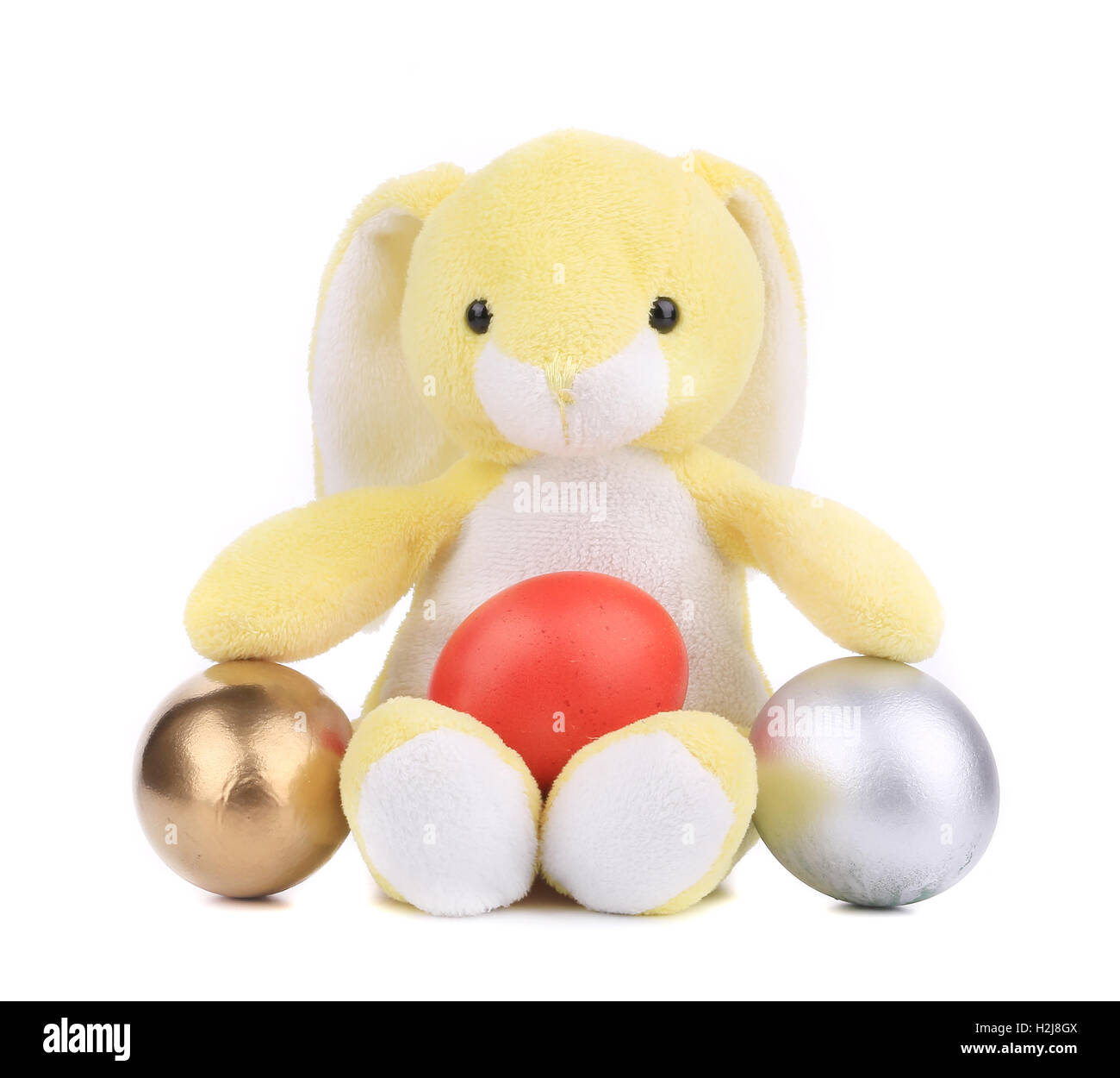 Yellow toy rabbit with easter eggs Stock Photo - Alamy