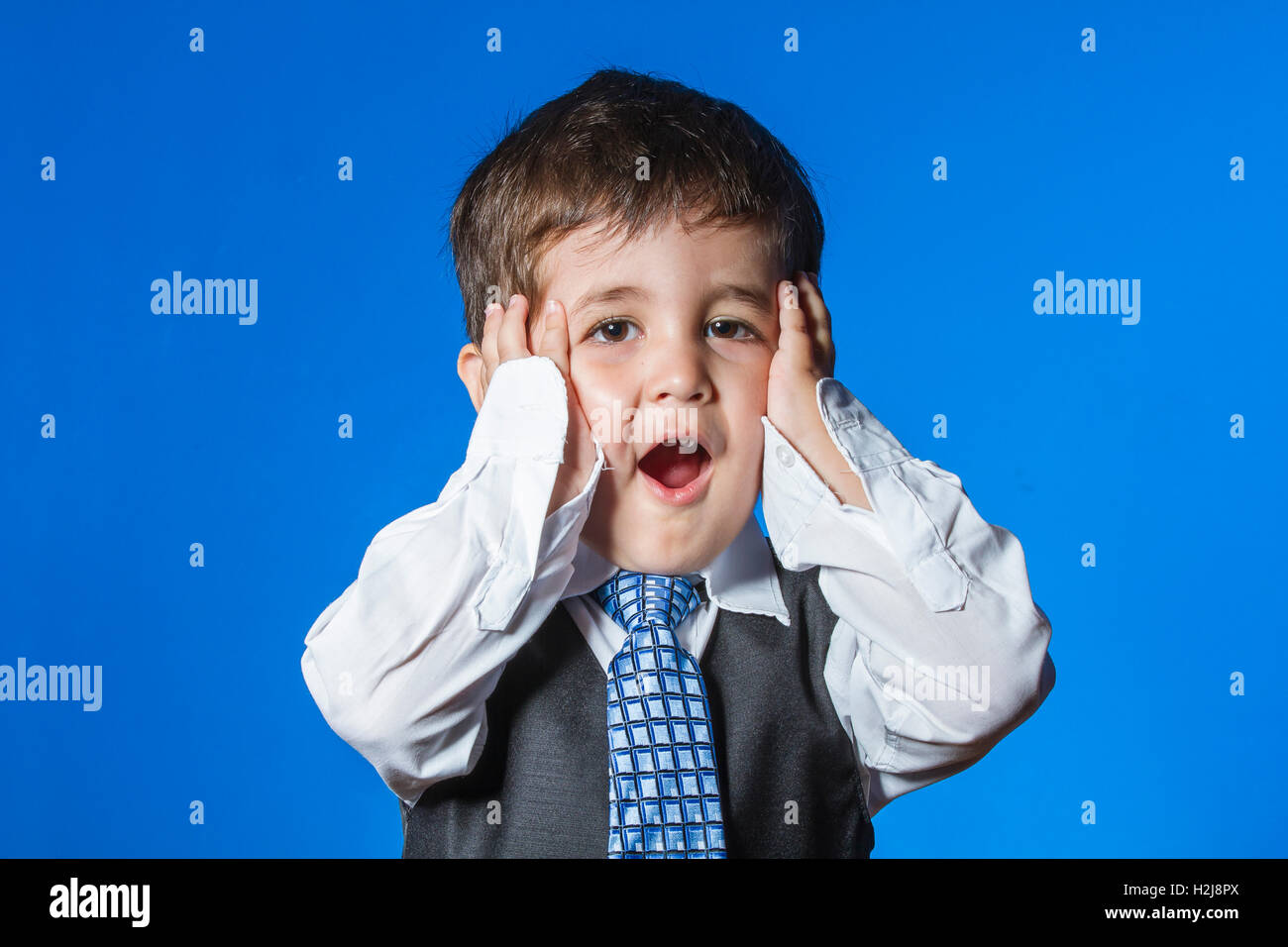 Leader, cute little boy portrait over blue chroma background Stock ...
