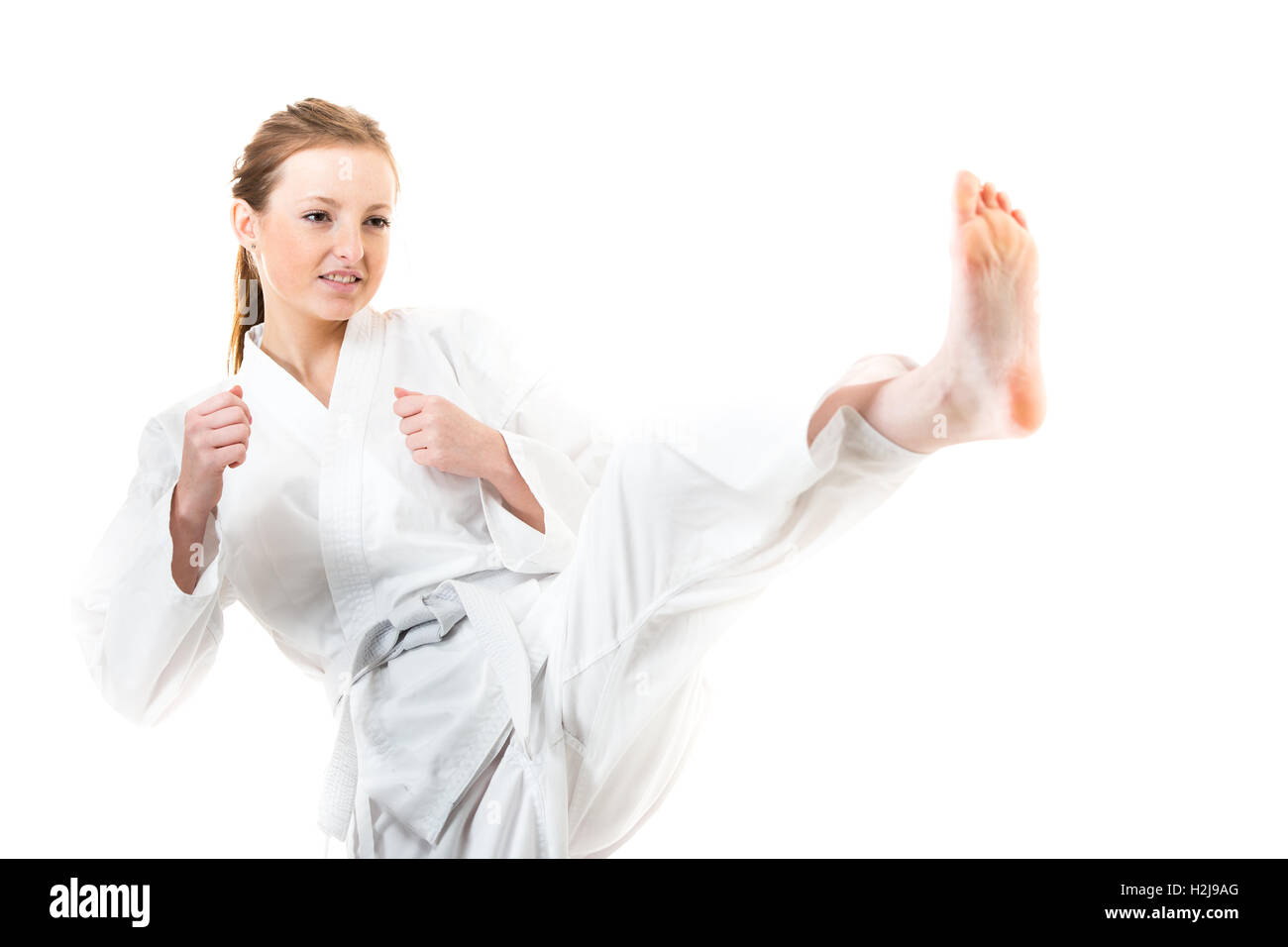 Beautiful caucasian, young, woman makes a kick Stock Photo - Alamy