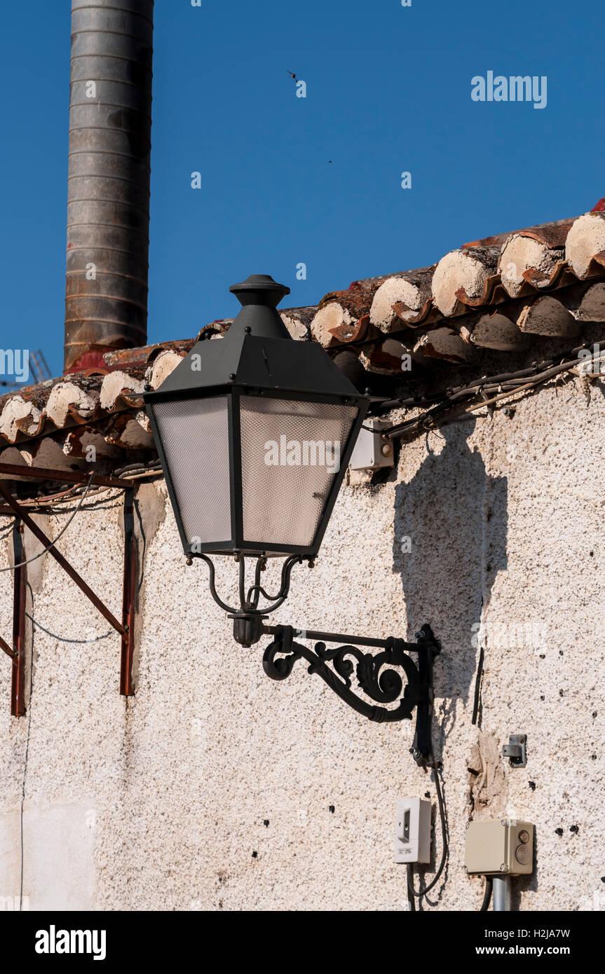 Street light on stone wall, spain Stock Photo - Alamy
