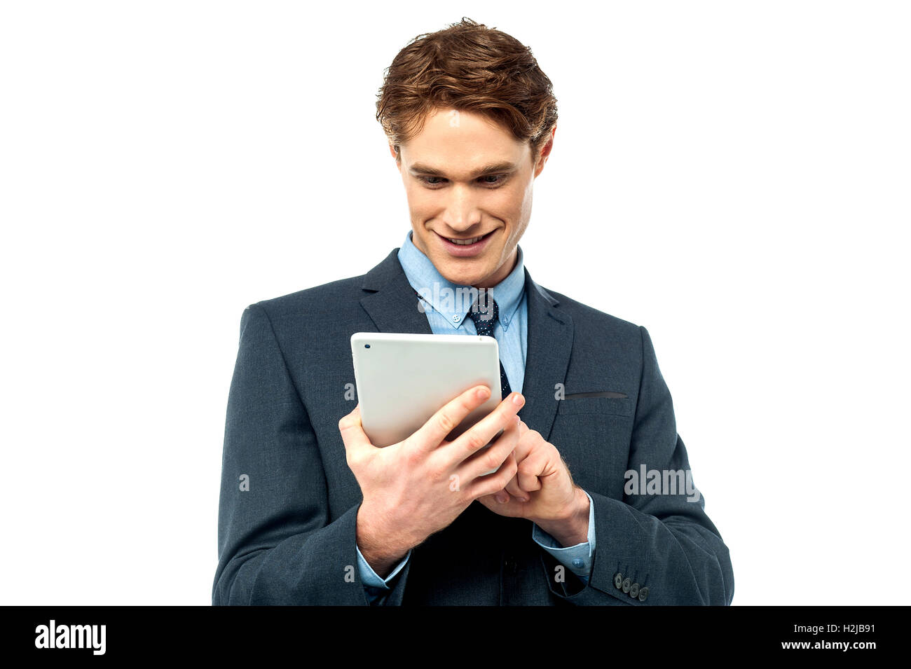 Corporate guy browsing on his tablet pc Stock Photo - Alamy