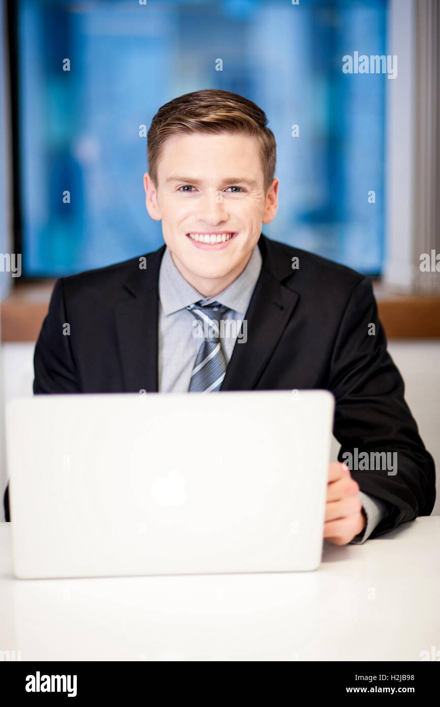 Corporate guy browsing in his laptop Stock Photo - Alamy