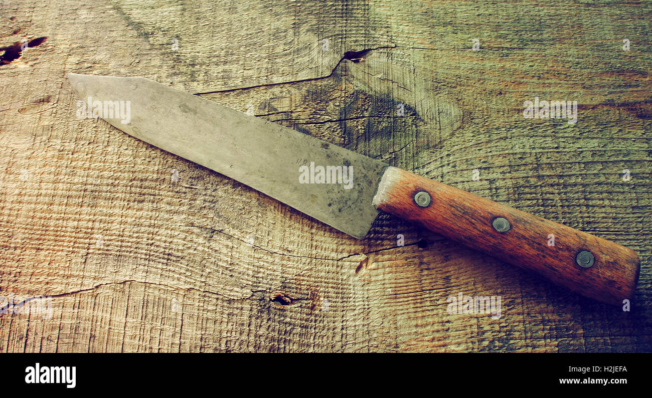 Old rusty knife on old wooden table background. Old style photo Stock ...