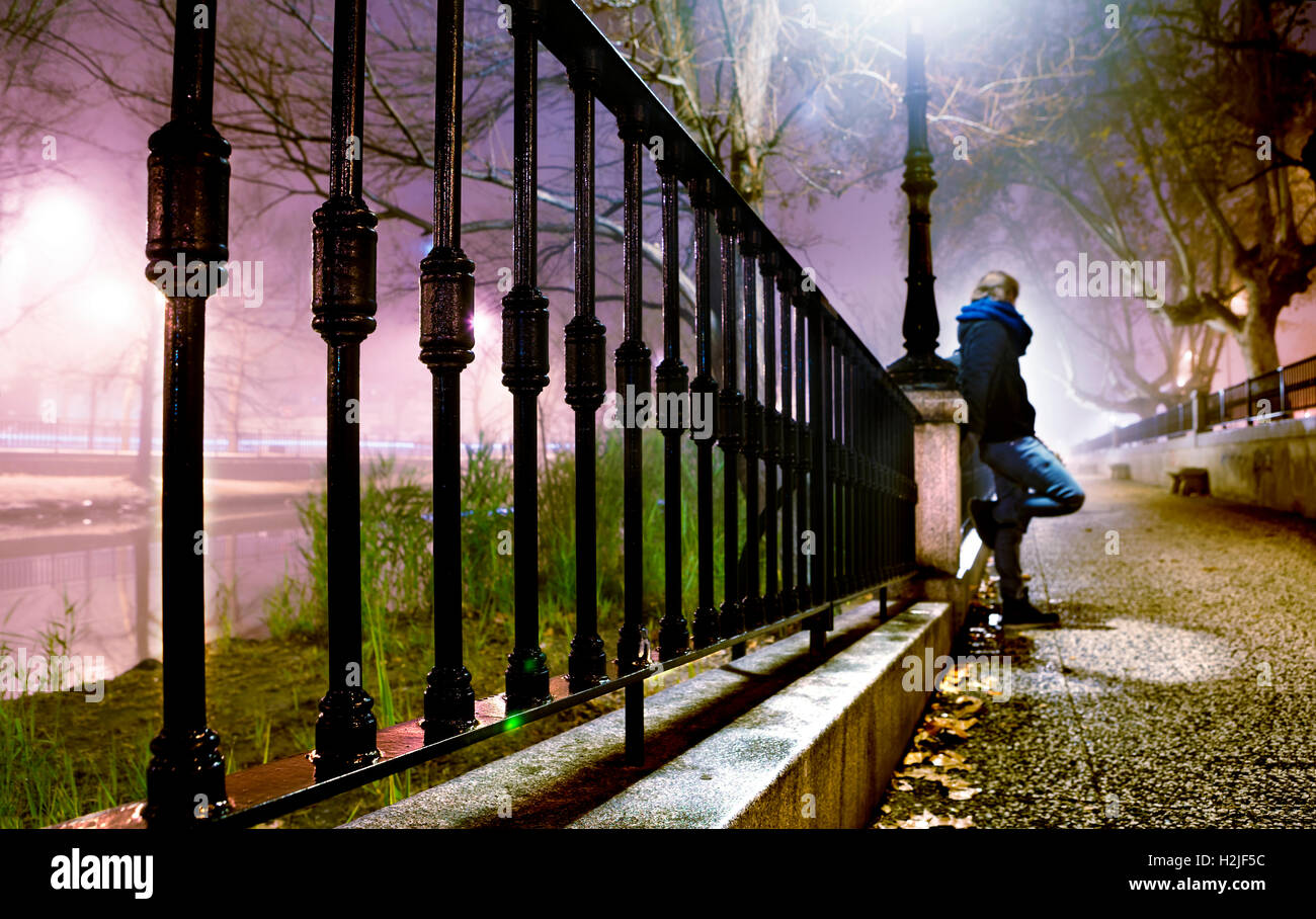 City street at night with trees,man and lamppost Stock Photo - Alamy