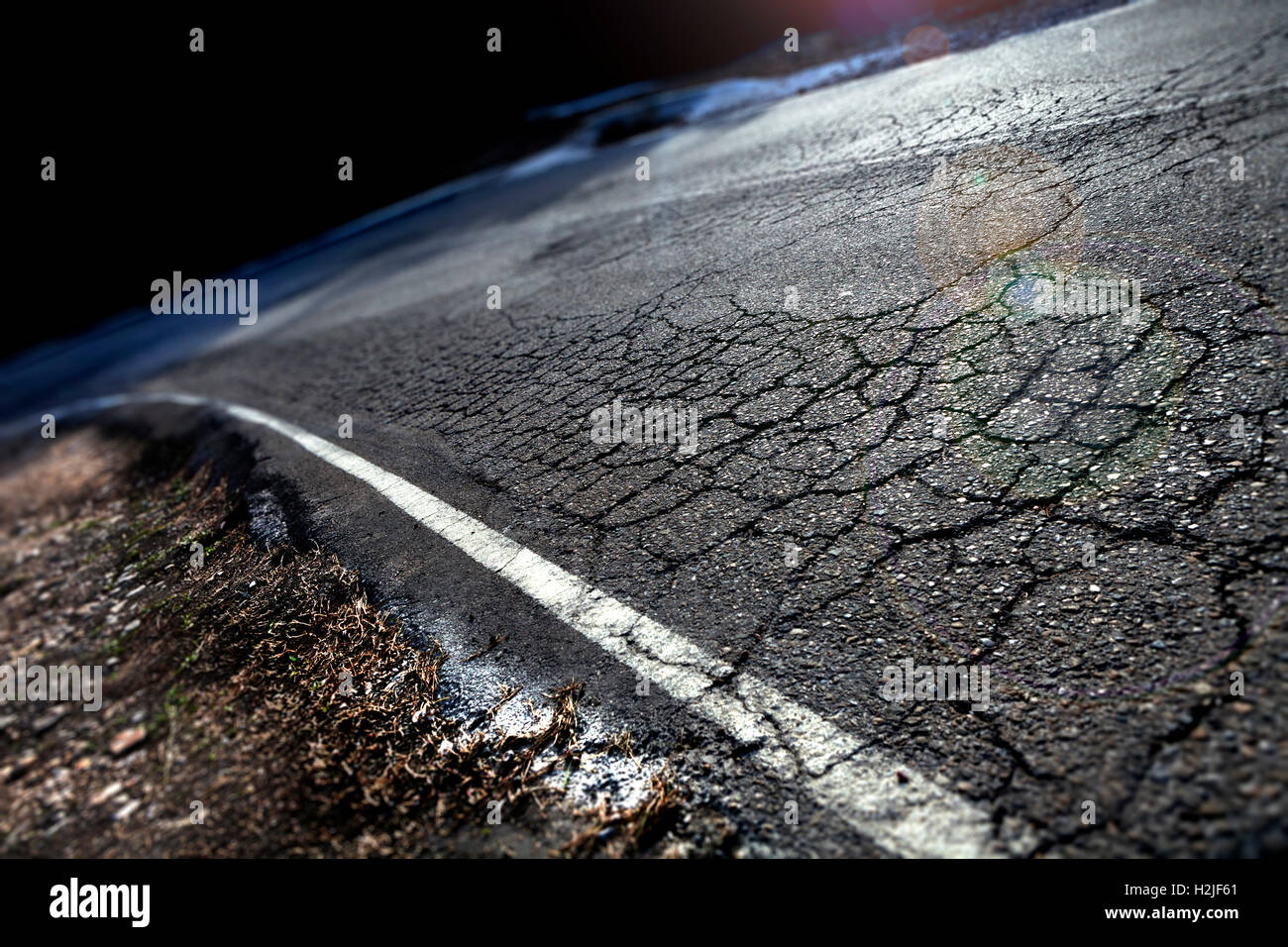 Travel concept. Cracked asphalt and curve road.Road lines Stock Photo ...