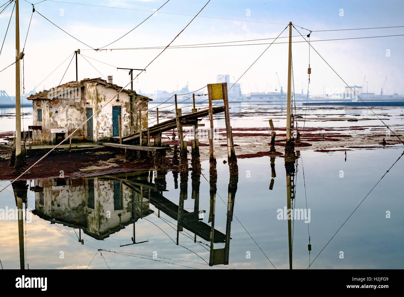 Old fishing house reflecting in the lagoon of Marina di Ravenna ...