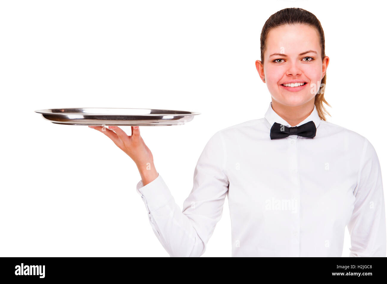 Young woman in waiter uniform holding tray isolated over white ...