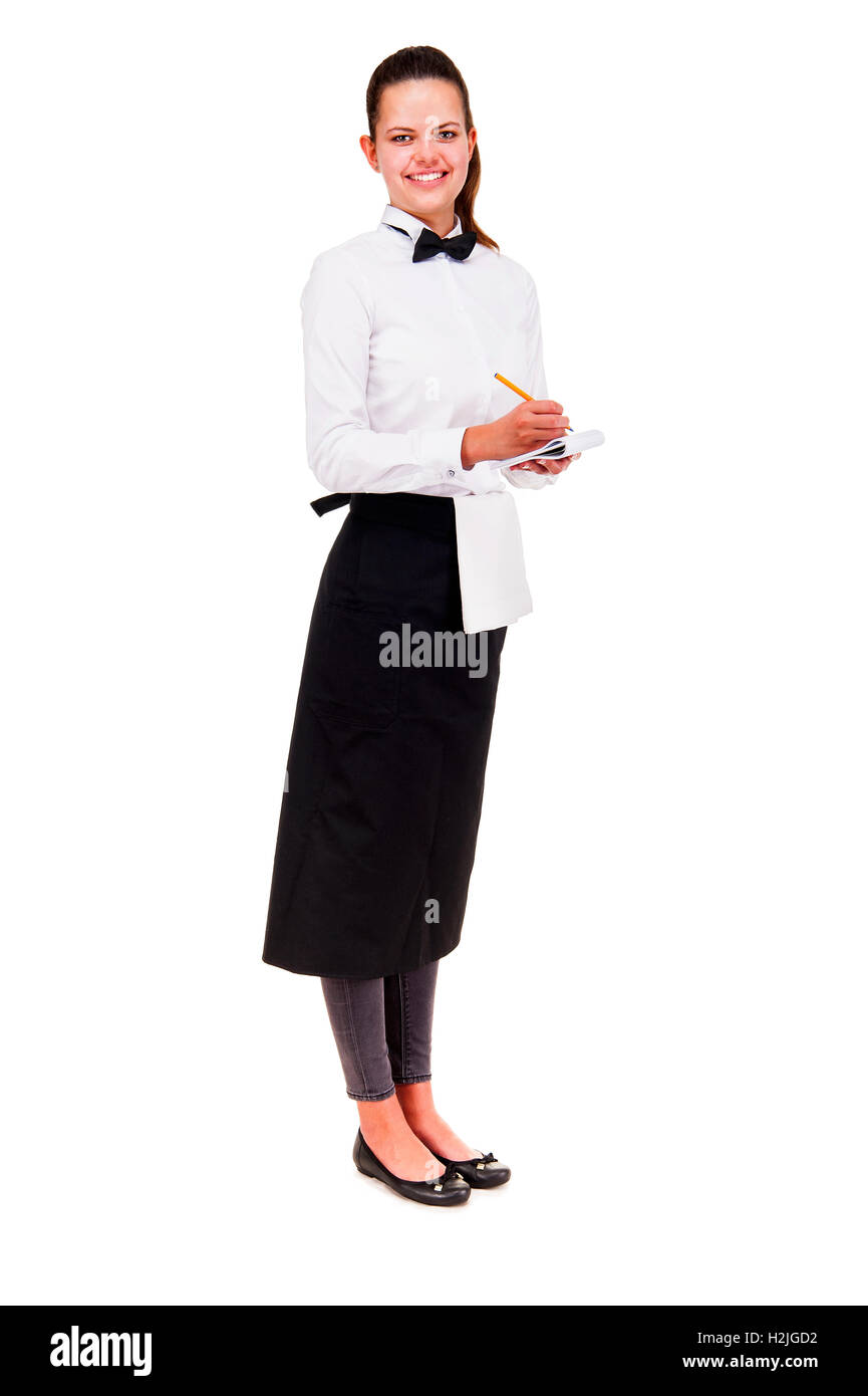 Young woman in waiter uniform holding notepad over white background ...