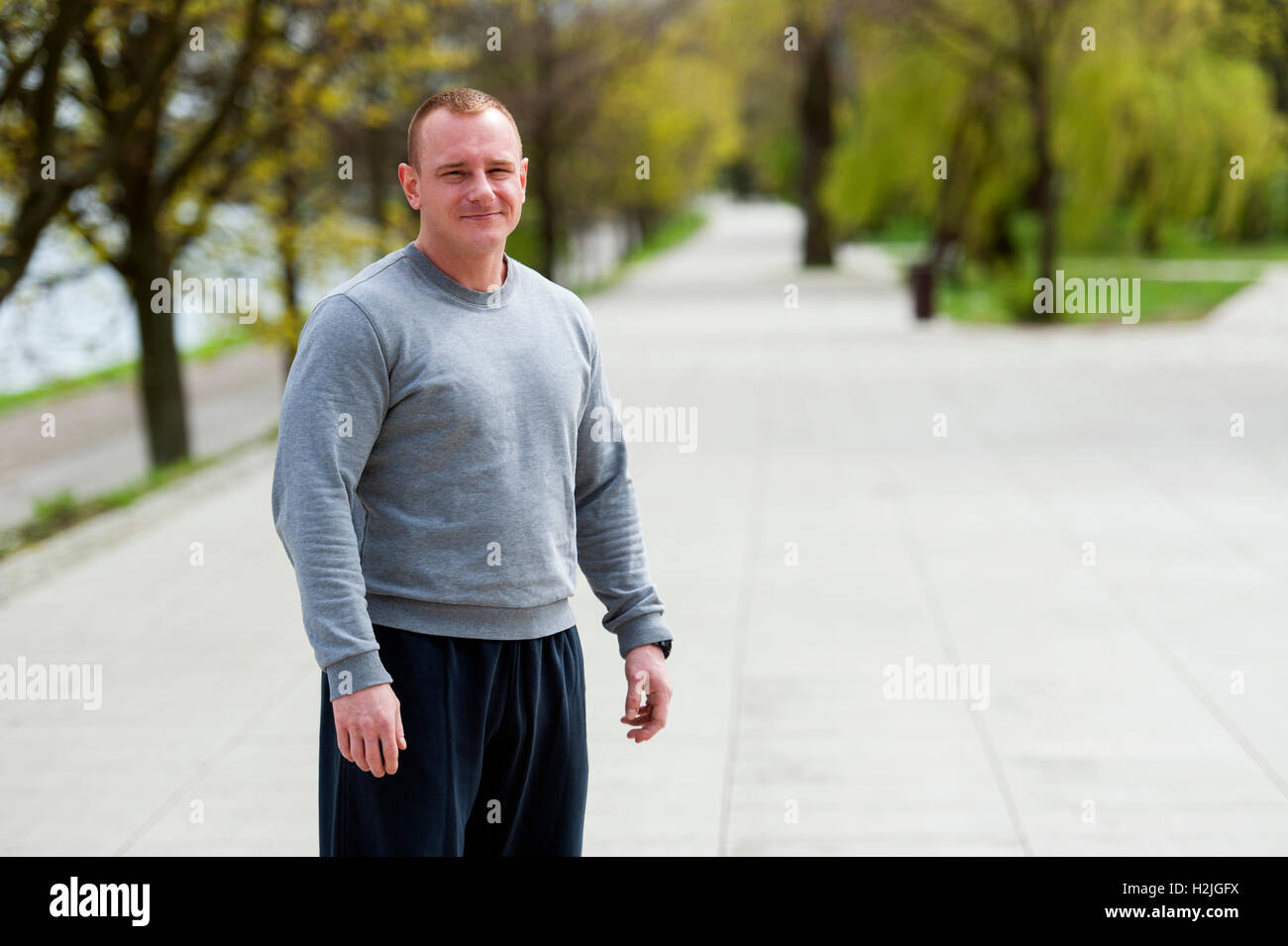 Active man with athletic body, exercise outdoore in park. Fit look ...