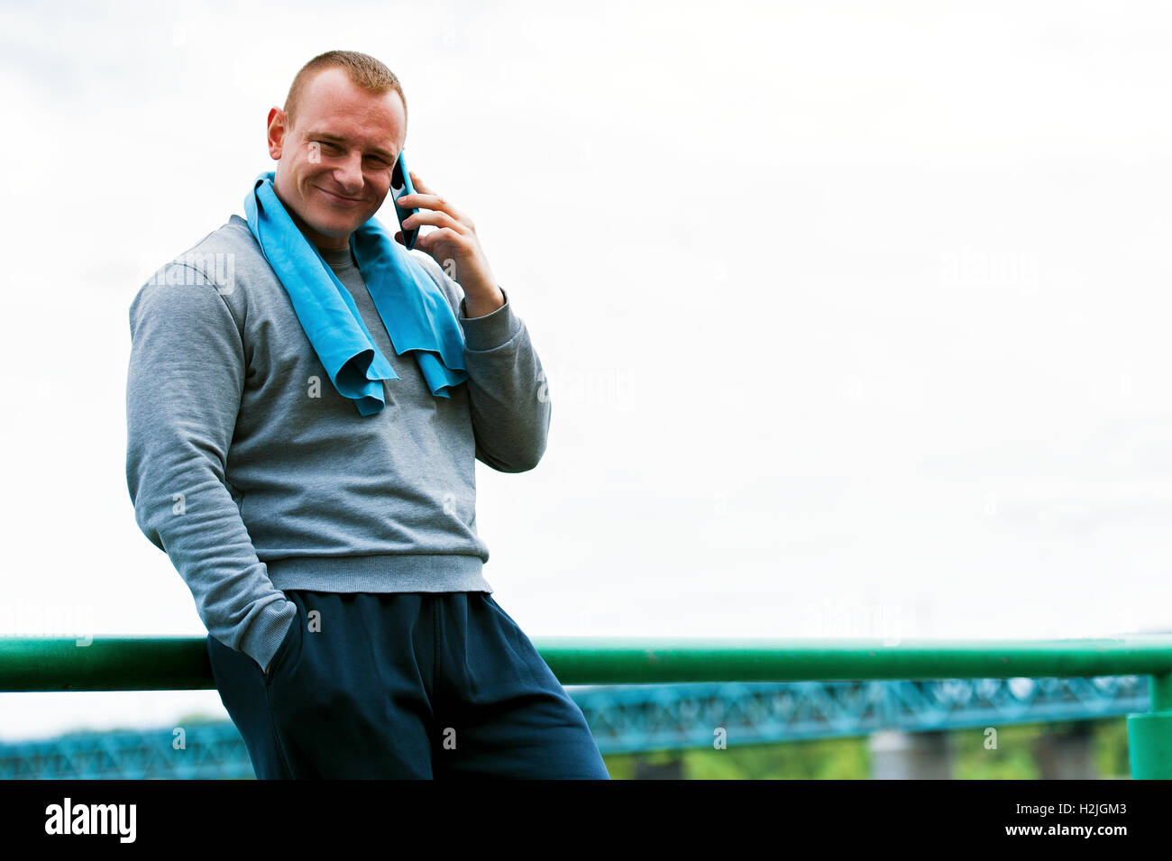 Active man talking by cell phone Stock Photo - Alamy