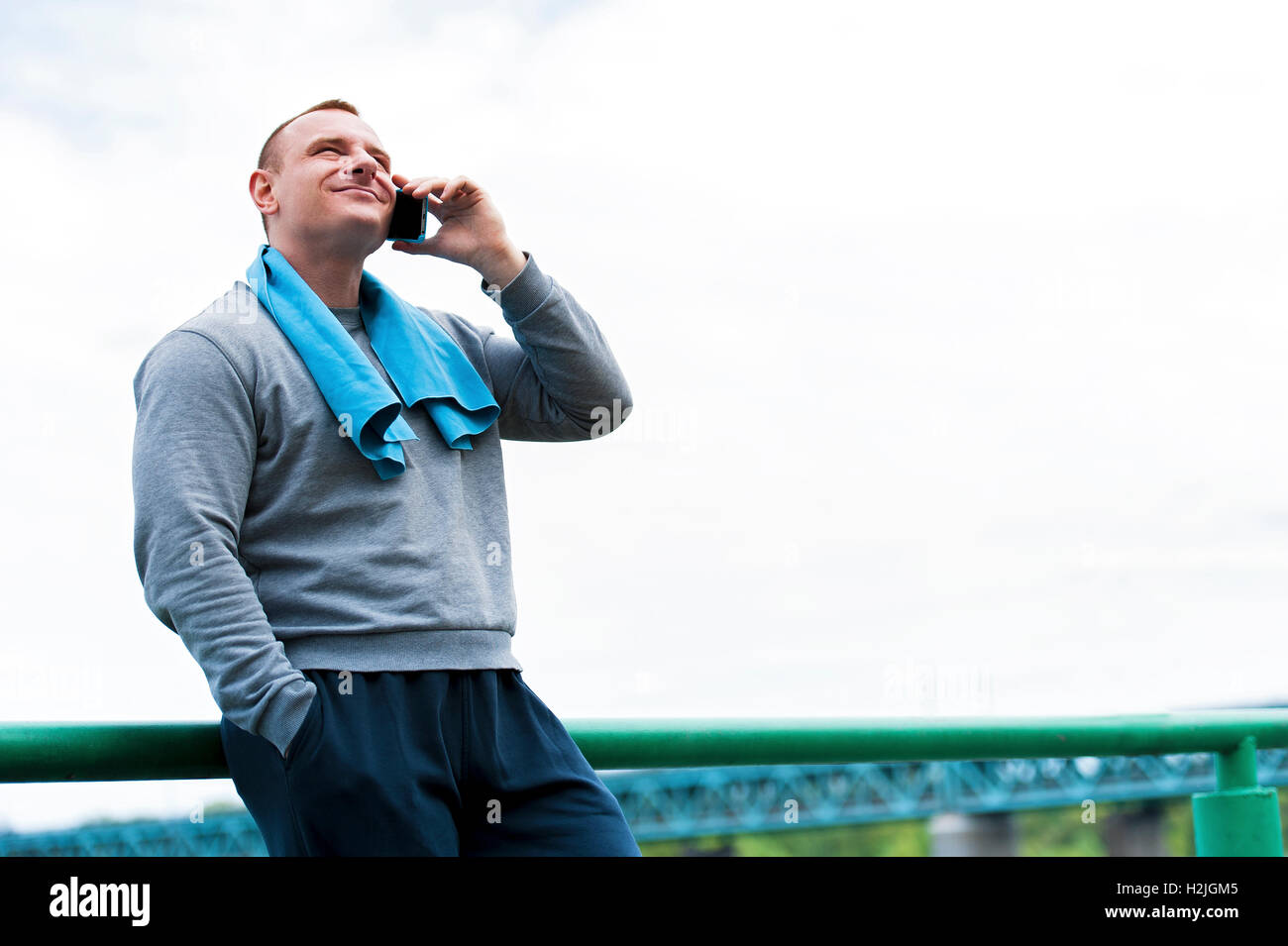 Active man talking by cell phone Stock Photo - Alamy