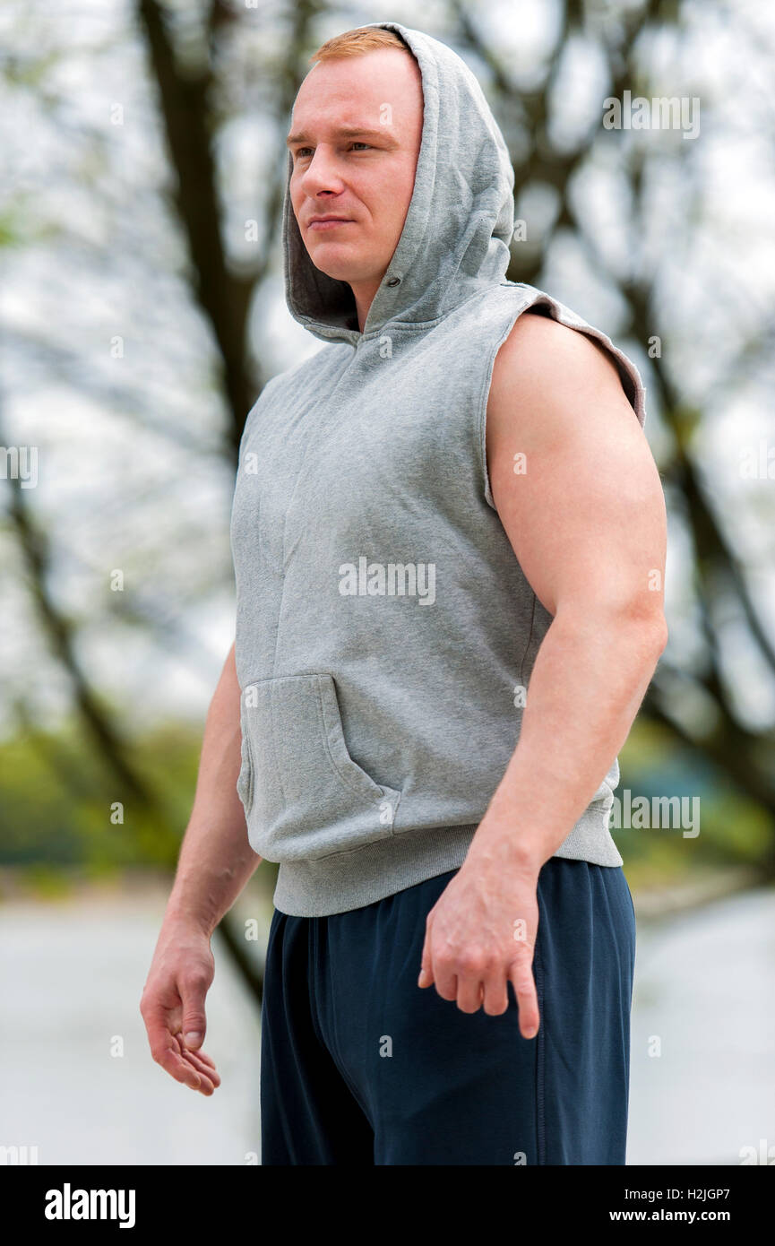 Workout man in hood resting. Outdoor Stock Photo - Alamy