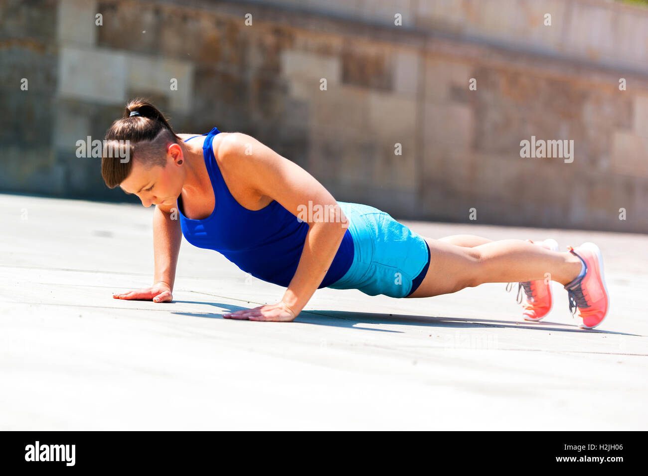 Woman doing pushups outdoor Stock Photo - Alamy