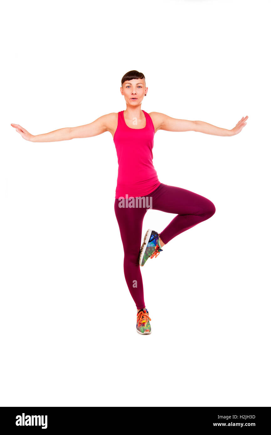 Young fitness woman balance, isolated over white background Stock Photo ...
