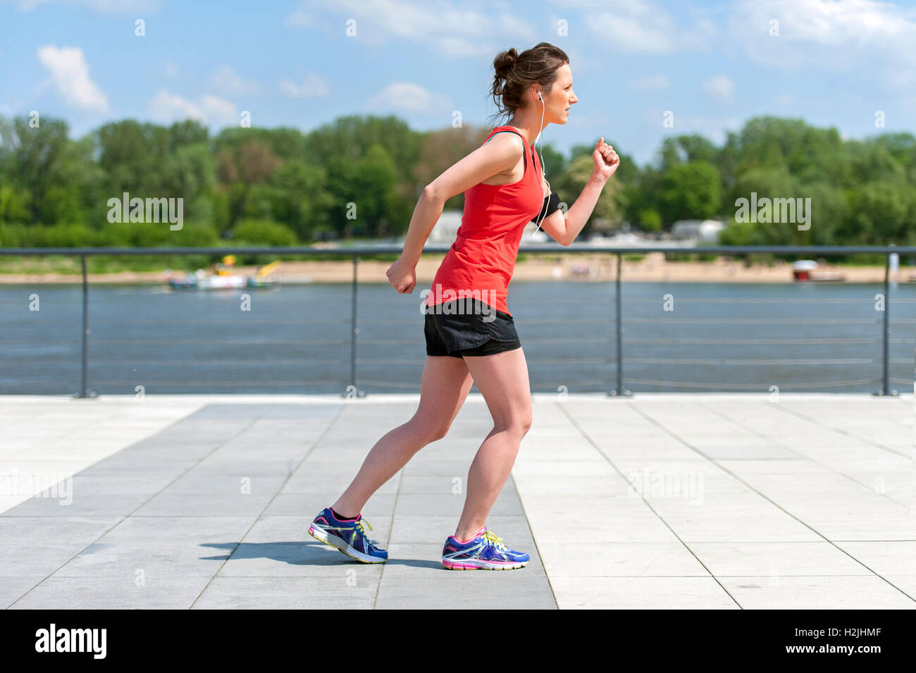 Fit woman jogging by the river Stock Photo - Alamy