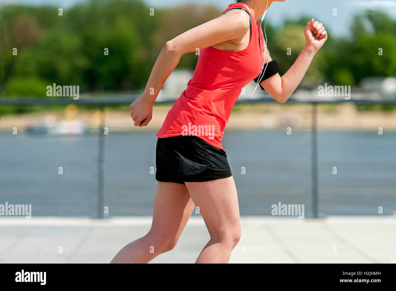 Fit woman jogging by the river Stock Photo - Alamy
