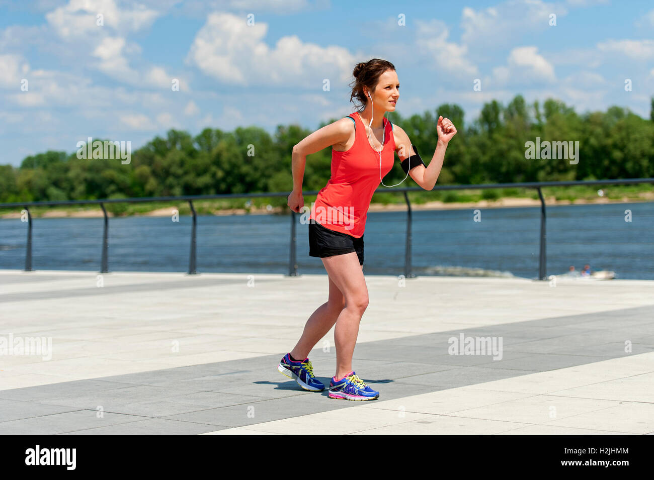 Fit woman jogging by the river Stock Photo - Alamy