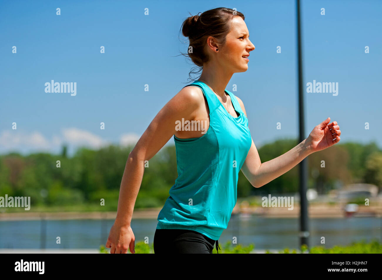 Fit woman jogging in park Stock Photo - Alamy