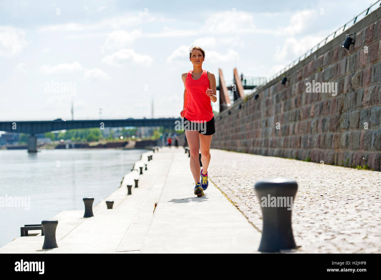 Fit woman jogging by the river Stock Photo - Alamy