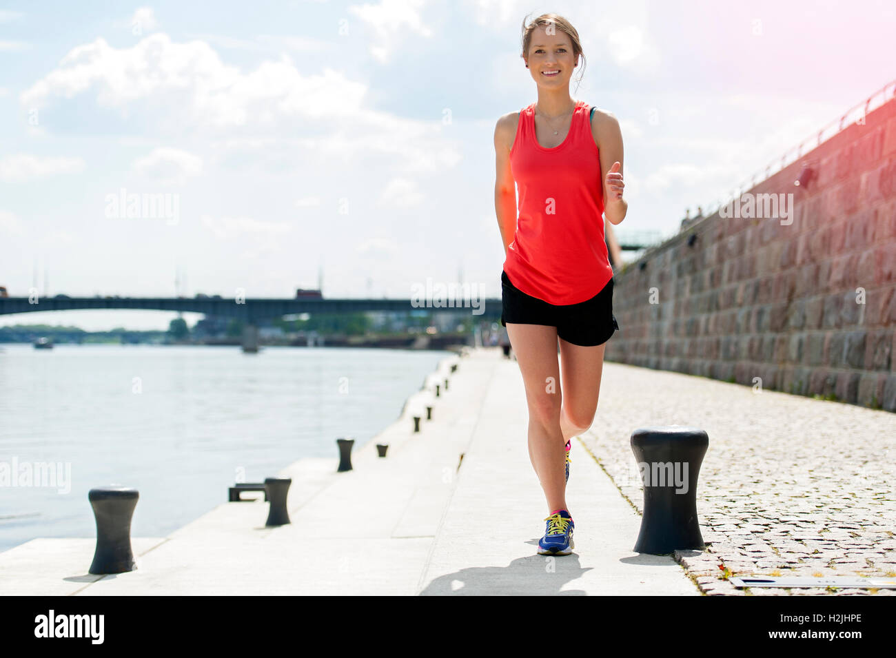 Fit woman jogging by the river Stock Photo - Alamy