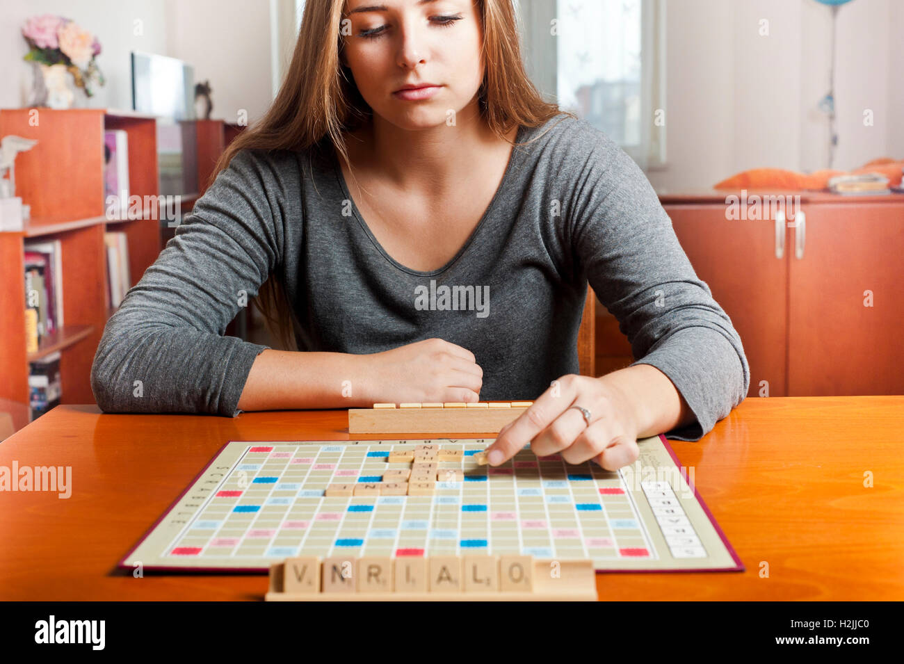 young brunette teenager girl playing scrabble Stock Photo - Alamy