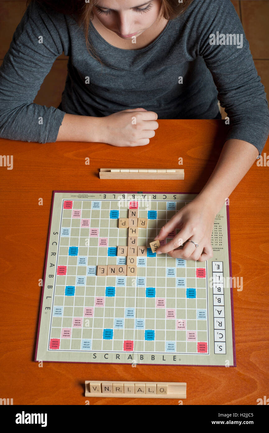 young brunette teenager girl playing scrabble Stock Photo - Alamy