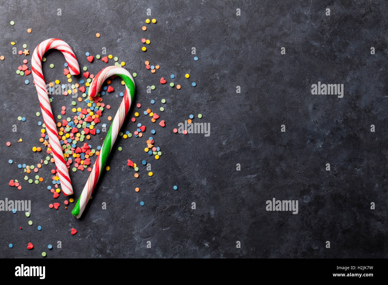 Candy canes over stone background. Top view with copy space Stock Photo ...