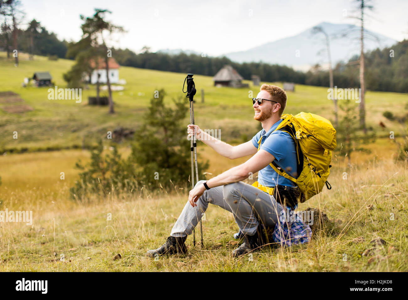 Young backpacking man rest at the hill Stock Photo - Alamy