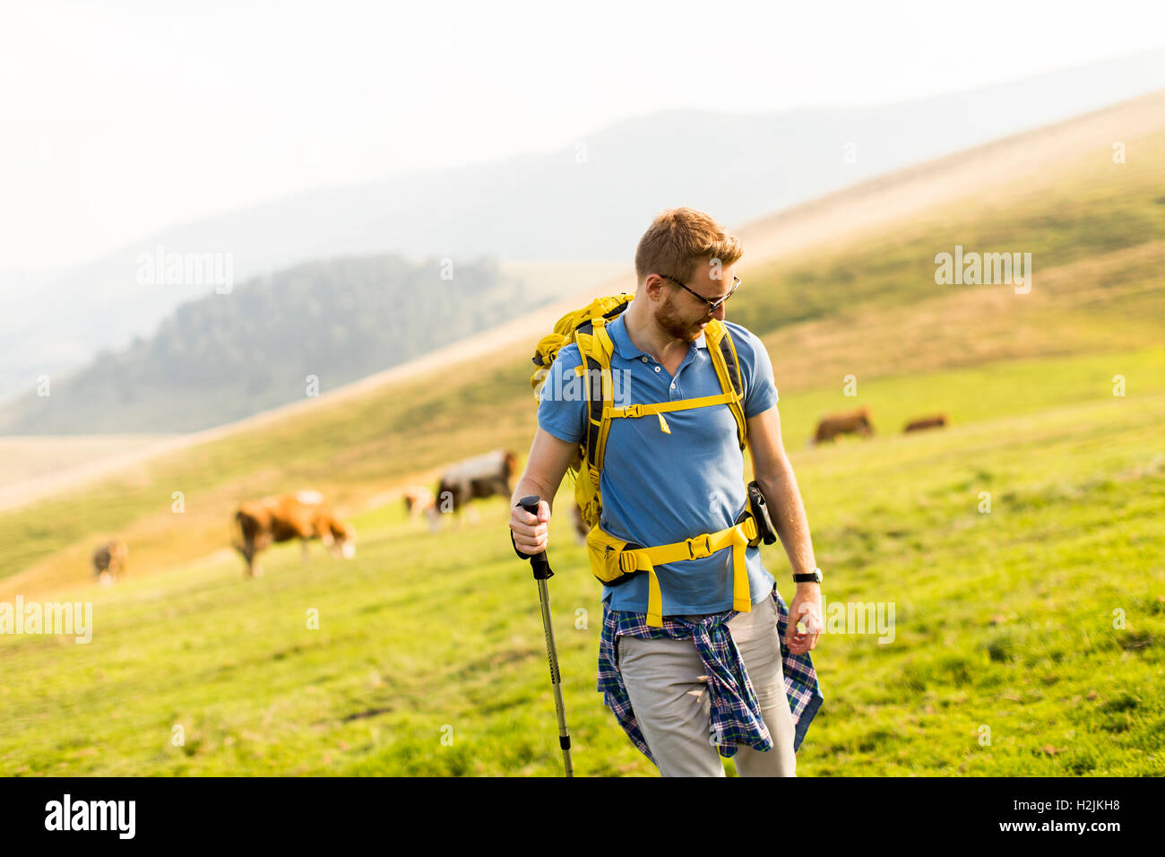 View of happy young man hiking in countryside Stock Photo - Alamy