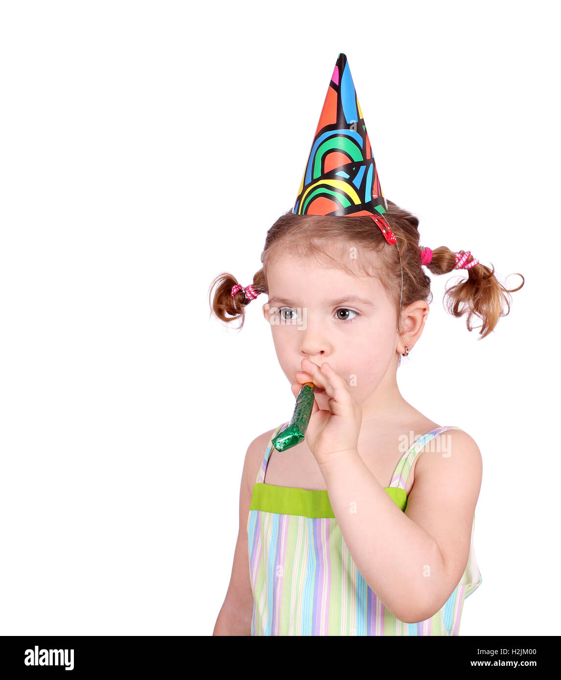 little girl with birthday hat and trumpet Stock Photo - Alamy