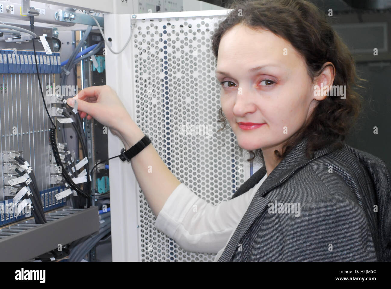 Woman working on telecommunication equipment Stock Photo - Alamy